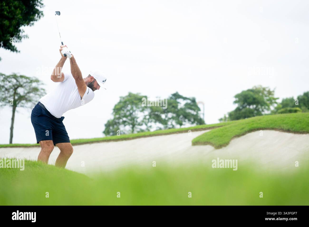 Captain Dustin Johnson of 4Aces GC hits his shot from a bunker on the ...