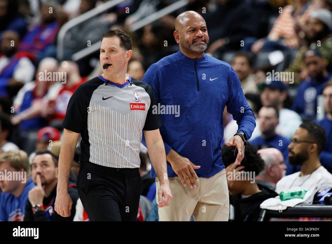 Referee Brian Forte passes Detroit Pistons head coach J.B. Bickerstaff ...