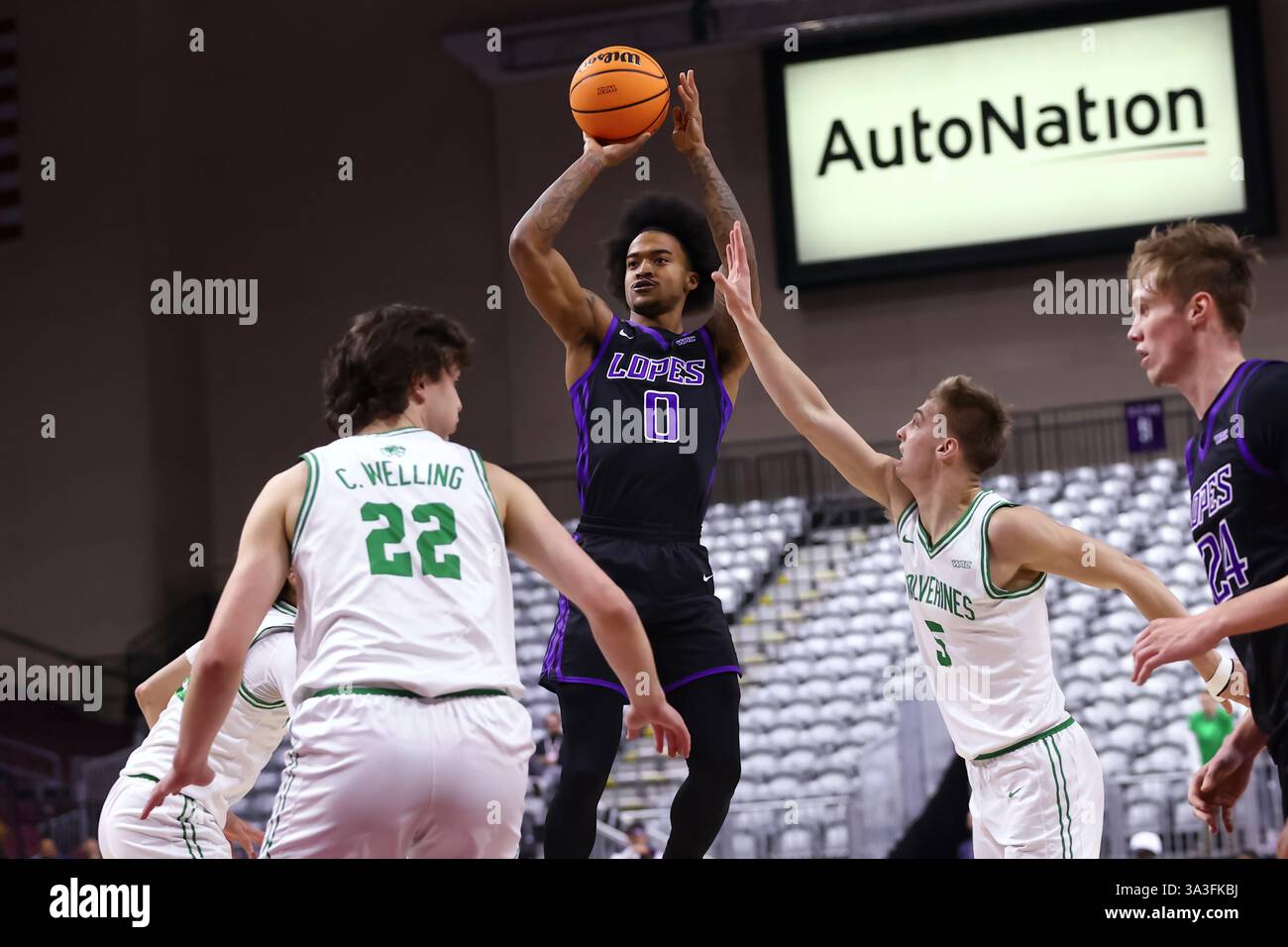 Grand Canyon guard Ray Harrison (0) shoots as Utah Valley guard Tanner ...