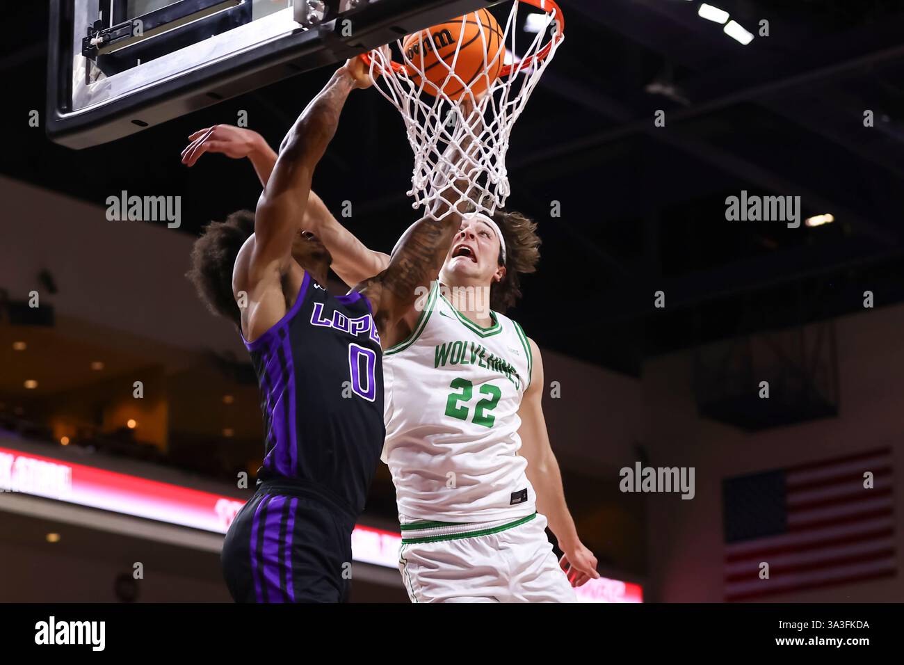 Grand Canyon guard Ray Harrison (0) dunks the ball under pressure from ...