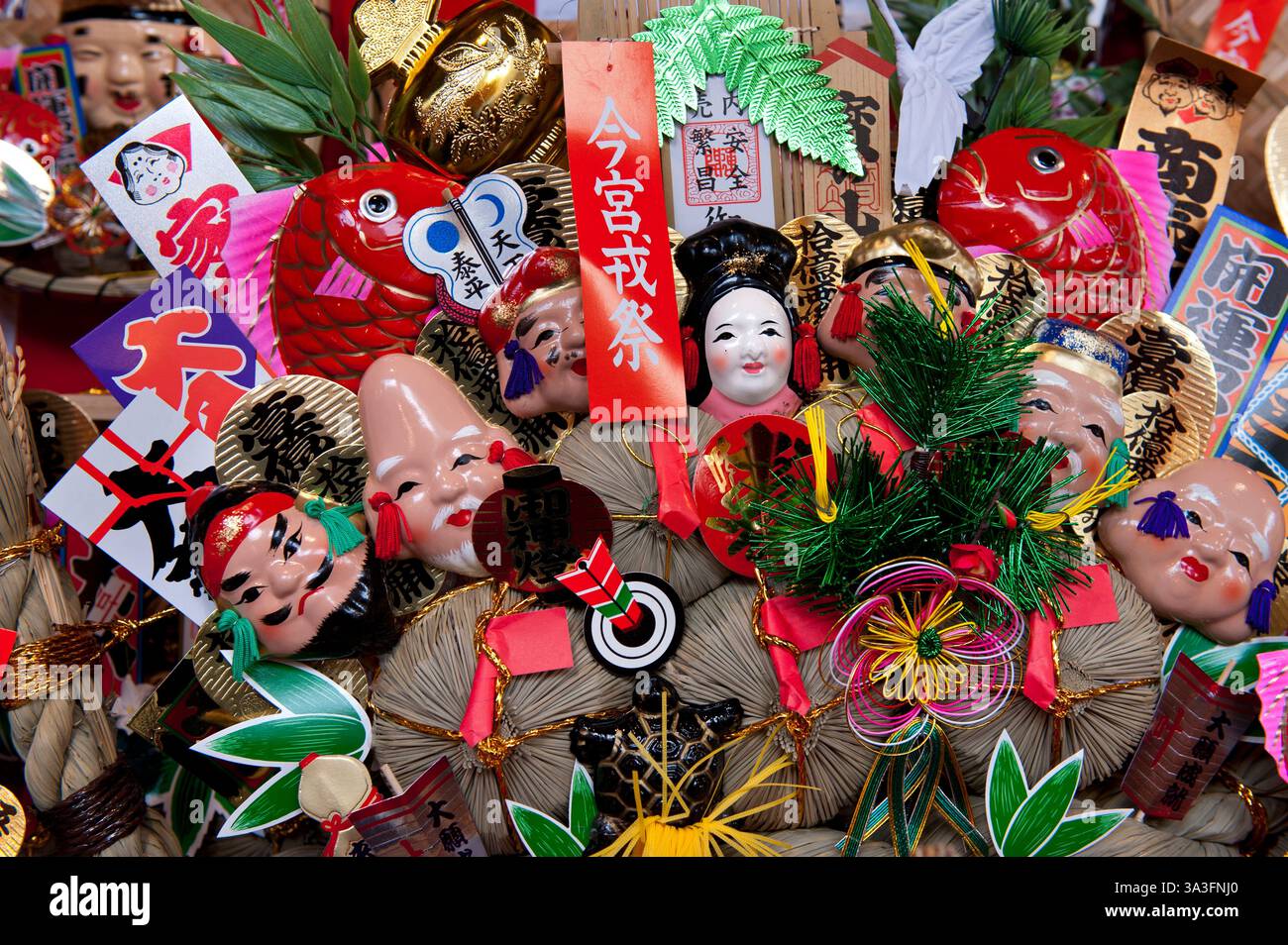 Colorful "kumade" (rake) decorated with a variety of good luck amulets ...