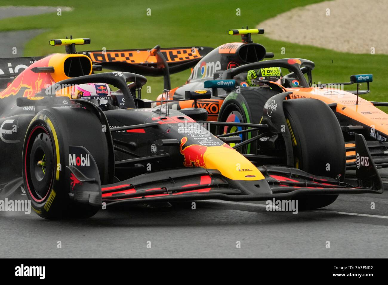 Red Bull driver Liam Lawson, left, of New Zealand passes McLaren driver Lando Norris of Britain ...