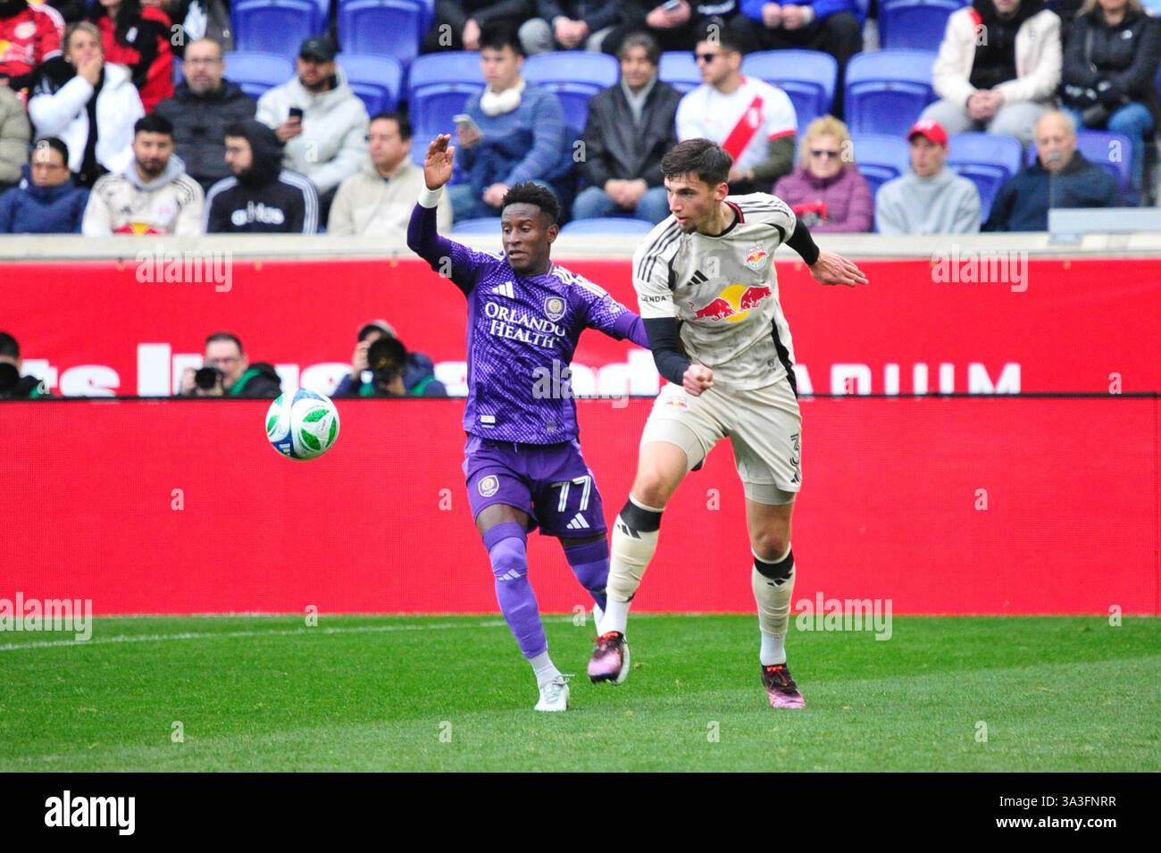 Orlando City midfielder Ivan Angulo (77) battles with New York defender ...