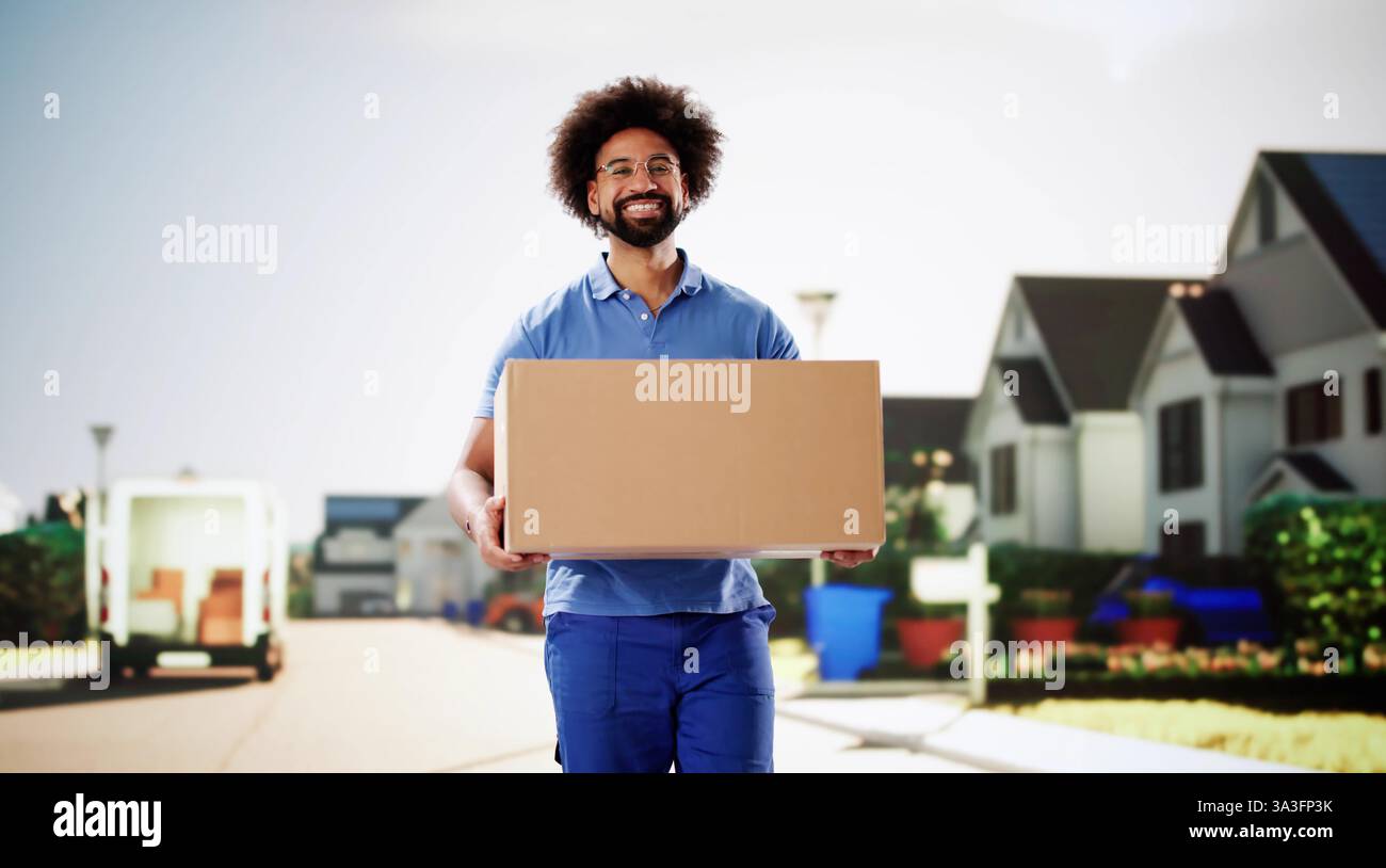 Smiling courier delivering a package in a postal service truck. Young ...