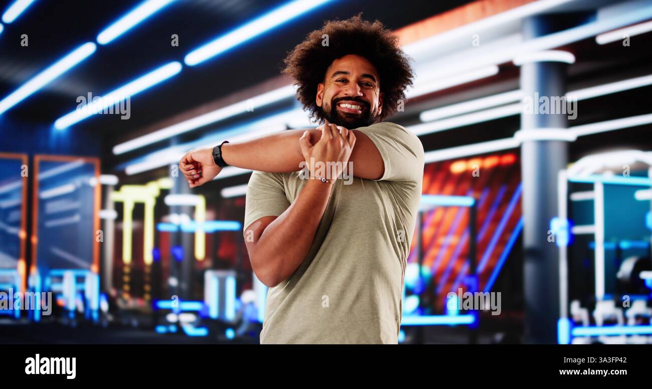 Flexible African American man in gym shows fitness trainer skills Stock ...