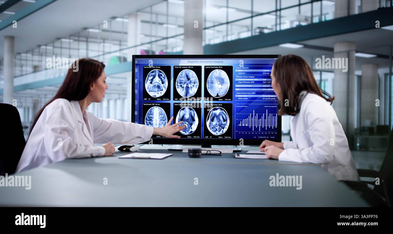 Brain surgeon analyzing MRI scans for patient's neurosurgery operation ...