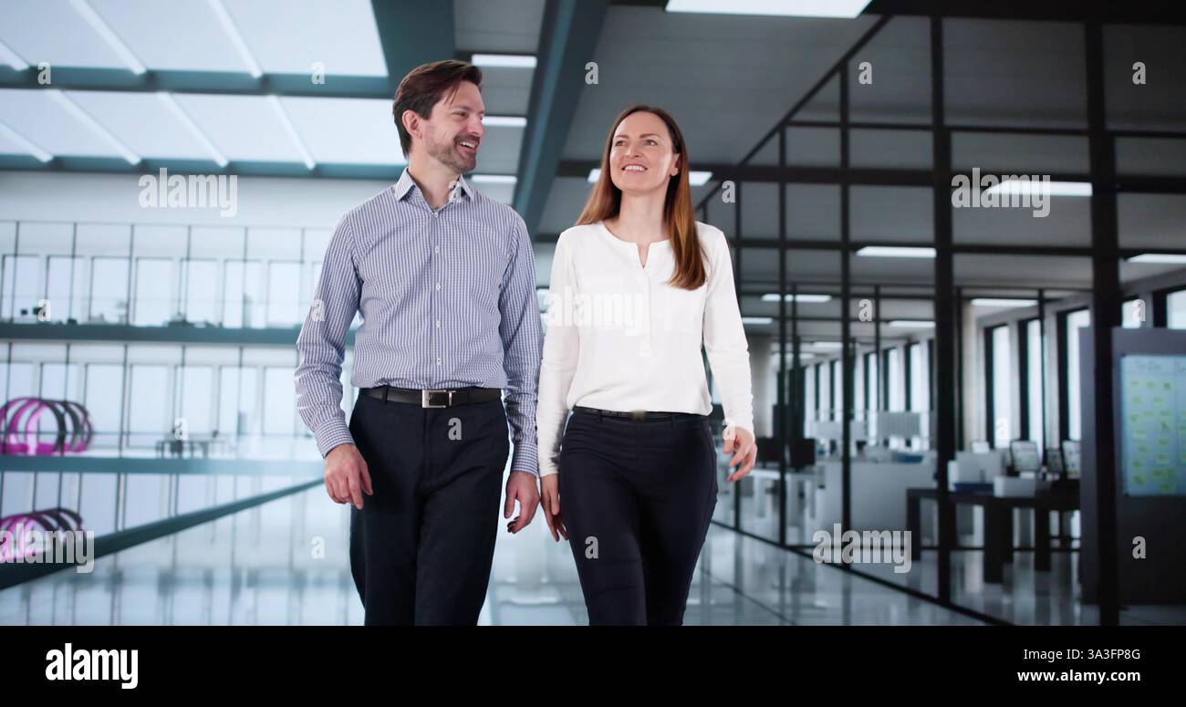 Colleagues walking together, smiling, having a happy workplace ...