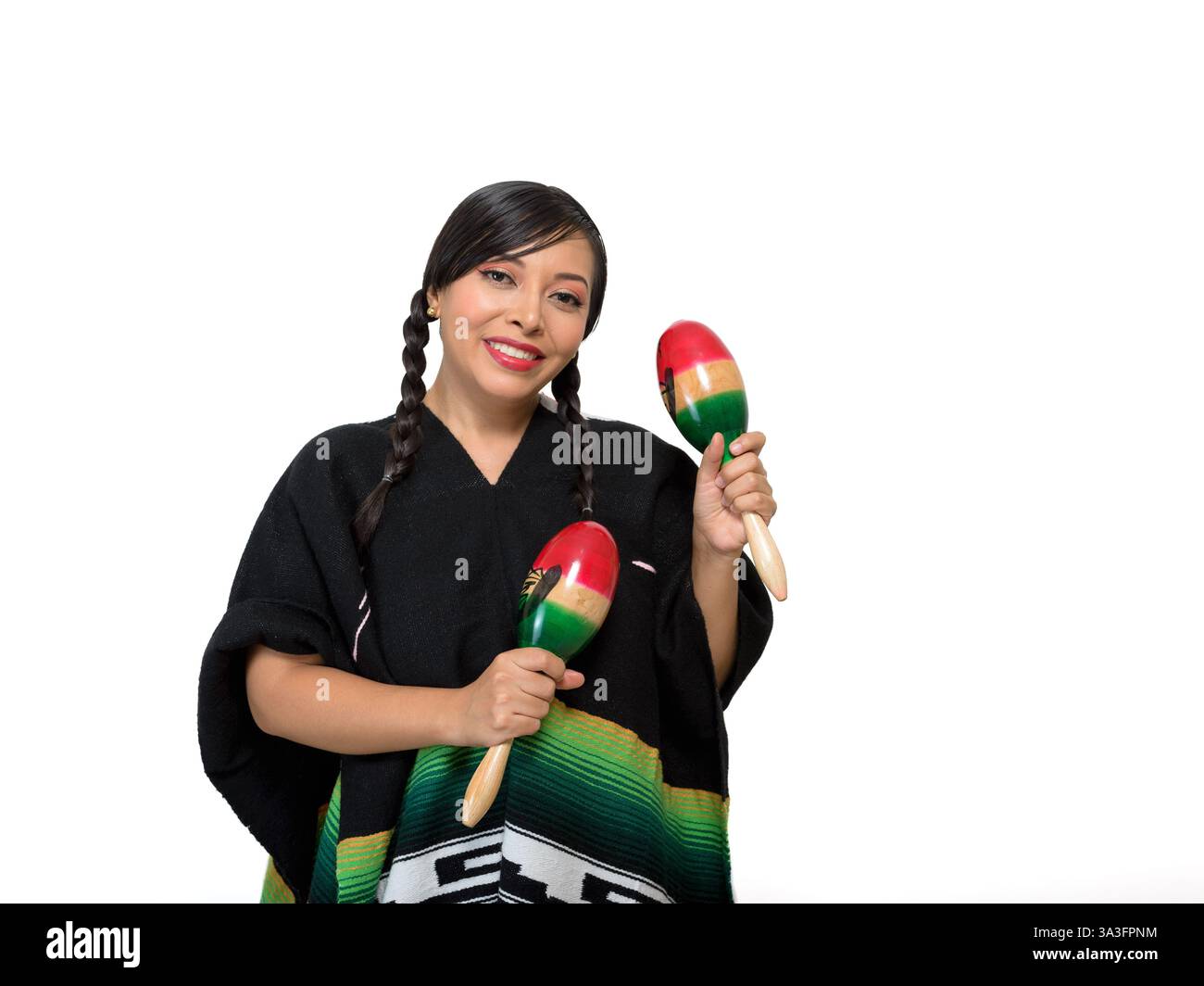 Mexican woman wearing colorful poncho plays maracas with positive ...