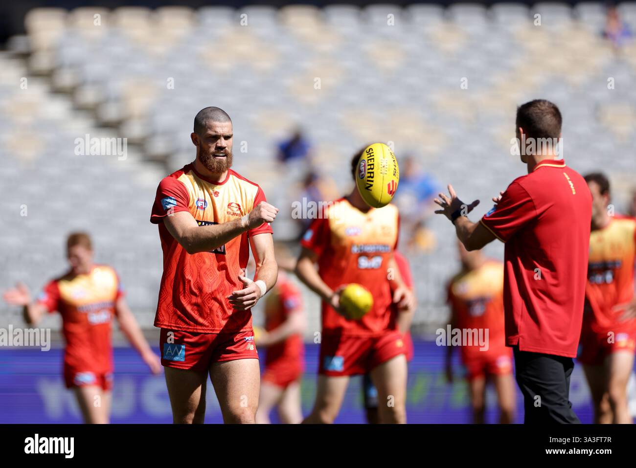 Sam Collins of the Suns is seen warming up before the AFL Round 1 match ...