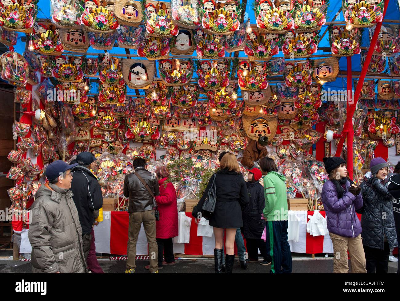Visitors to Imamiya Ebisu Shrine pick out "mi" (Ebisu baskets) and ...