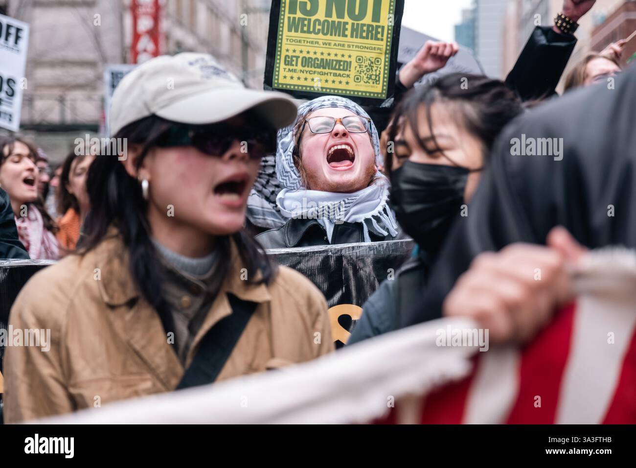 New York, USA. 15th Mar, 2025. Protesters shouting as they march up 8th ...