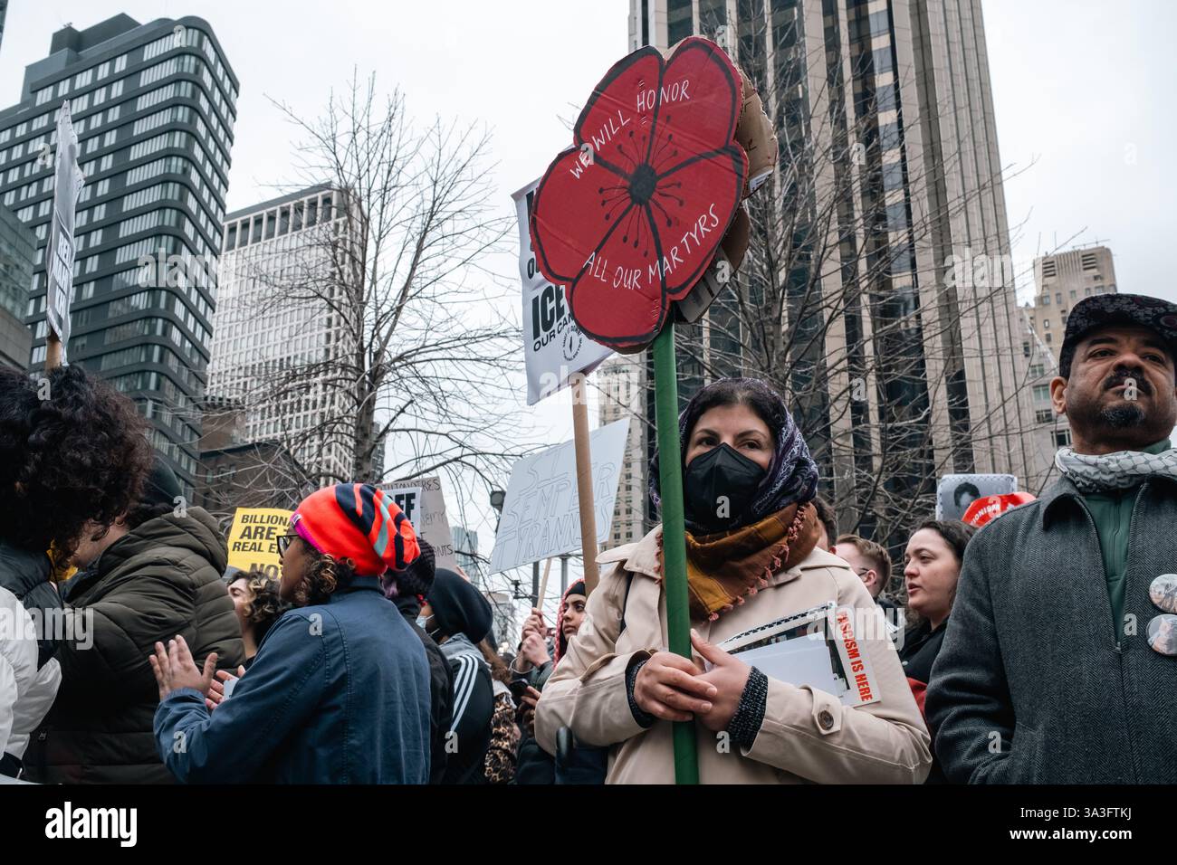 New York, USA. 15th Mar, 2025. A protester holds a placard in the shape ...