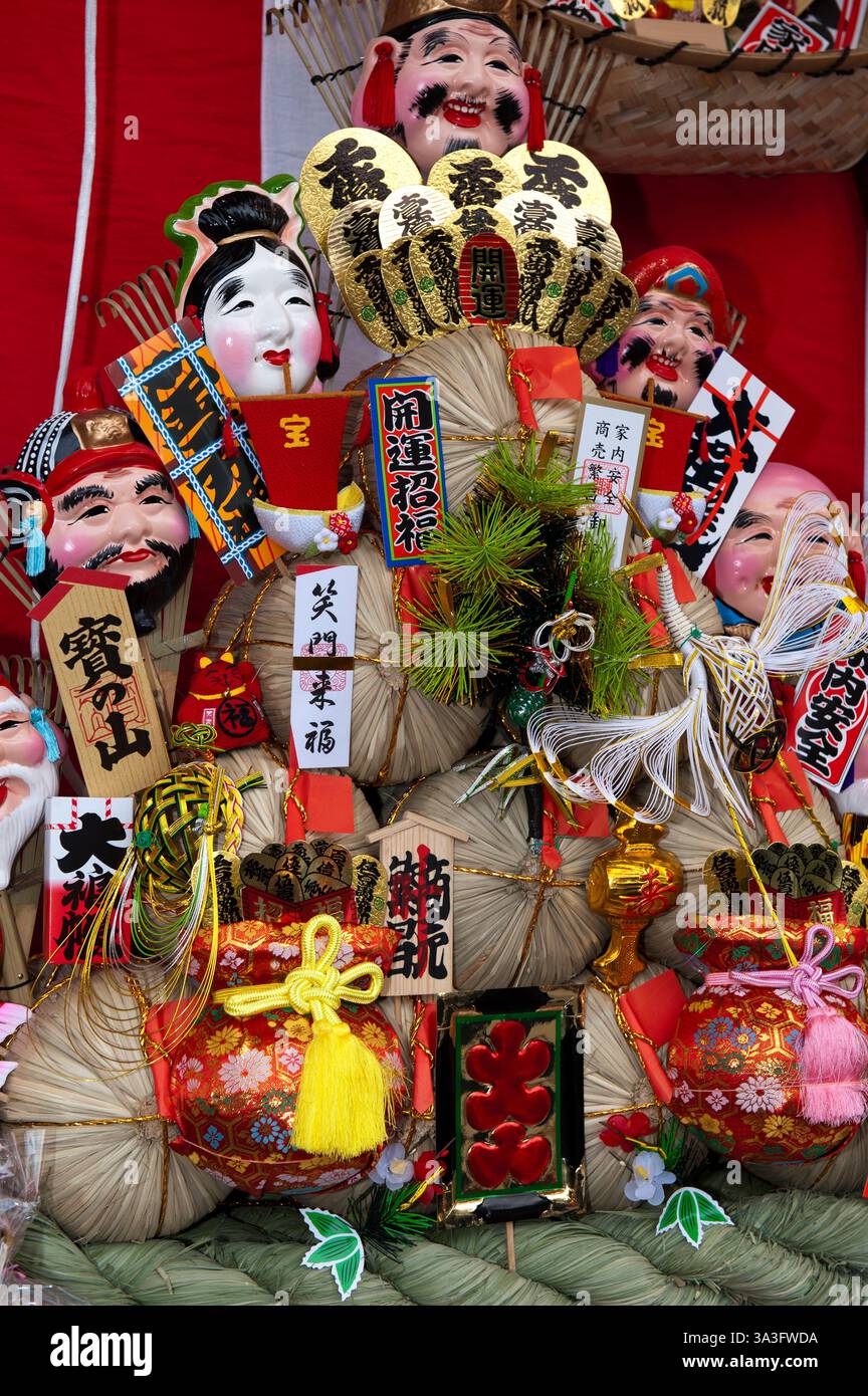 Colorful "kumade" (rake) decorated with a variety of good luck amulets ...