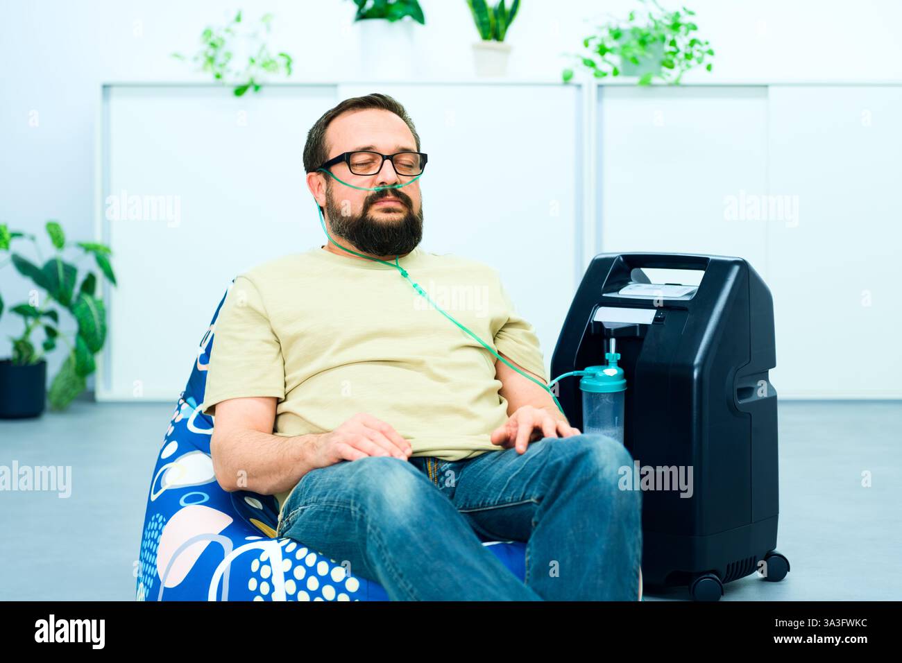 Oxygen therapy, supplemental oxygen. Man inhaling oxygen through nasal ...