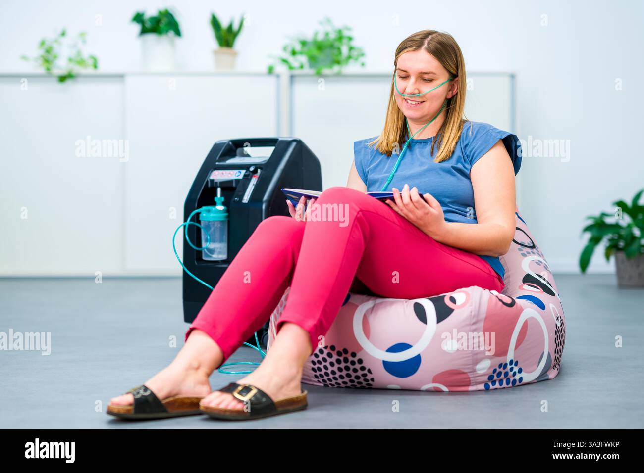 Oxygen therapy, supplemental oxygen. Young woman inhaling oxygen ...