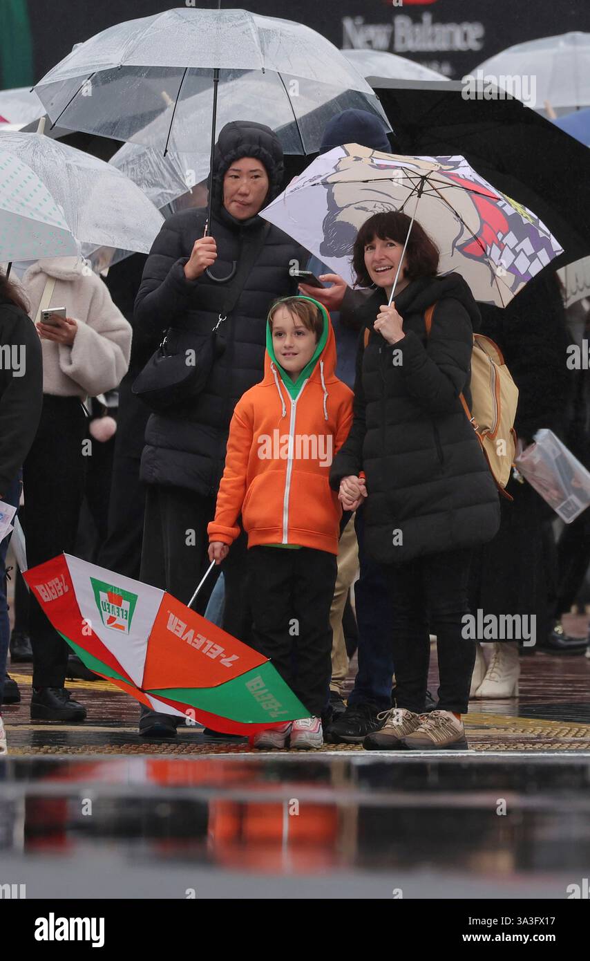 People walk with umbrella in cold rain near JR Shibuya station in ...