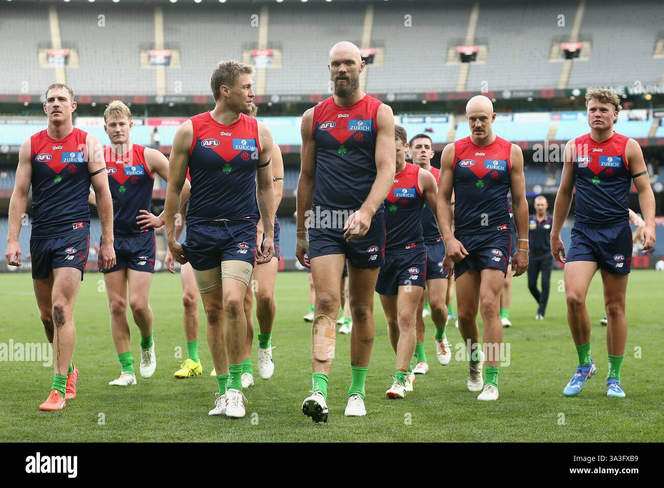 Melbourne, Australia. 16th Mar, 2025. Melbourne Demons players walk off ...