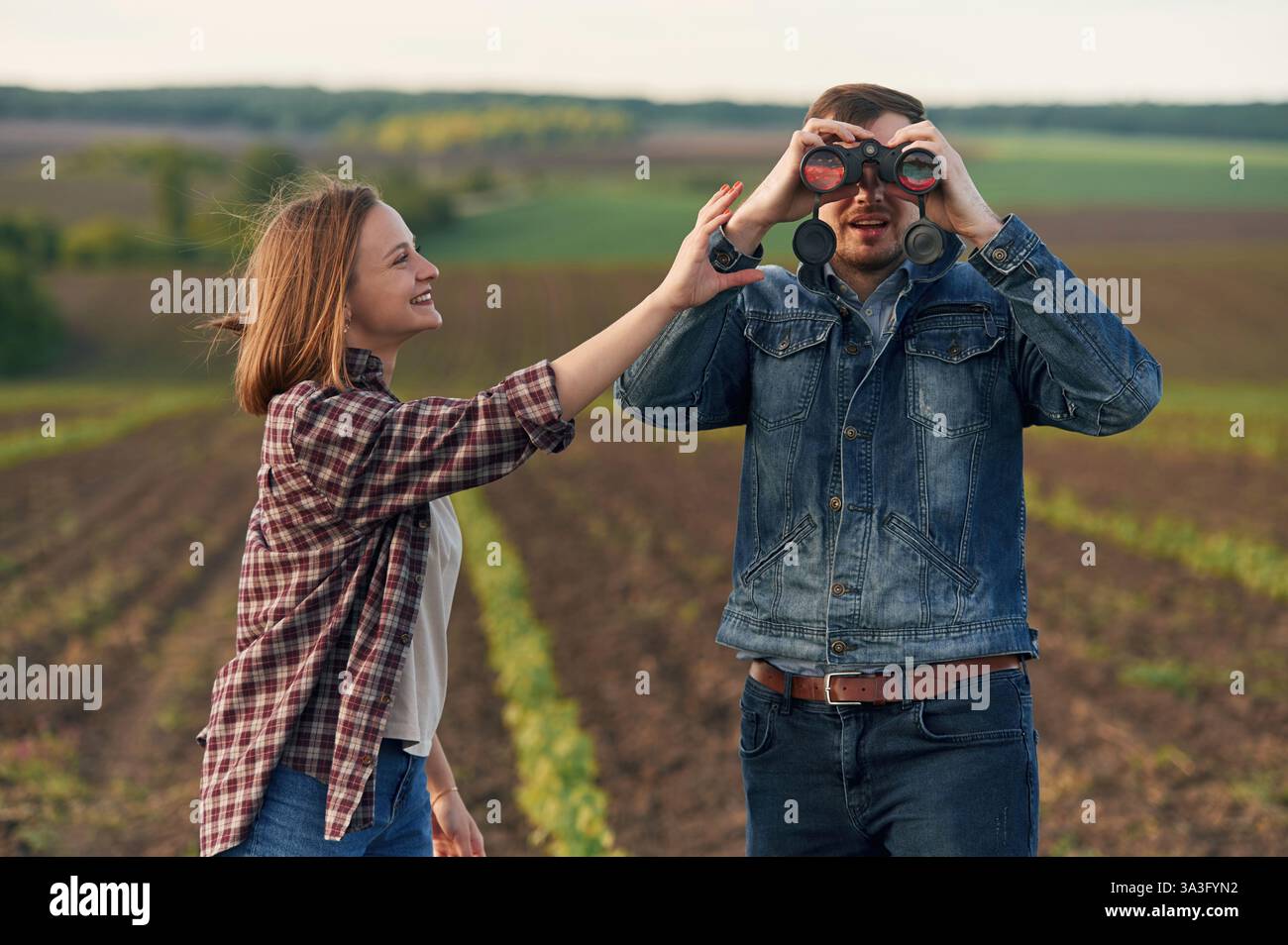 Using binoculars. Lovely beautiful couple are together on the ...
