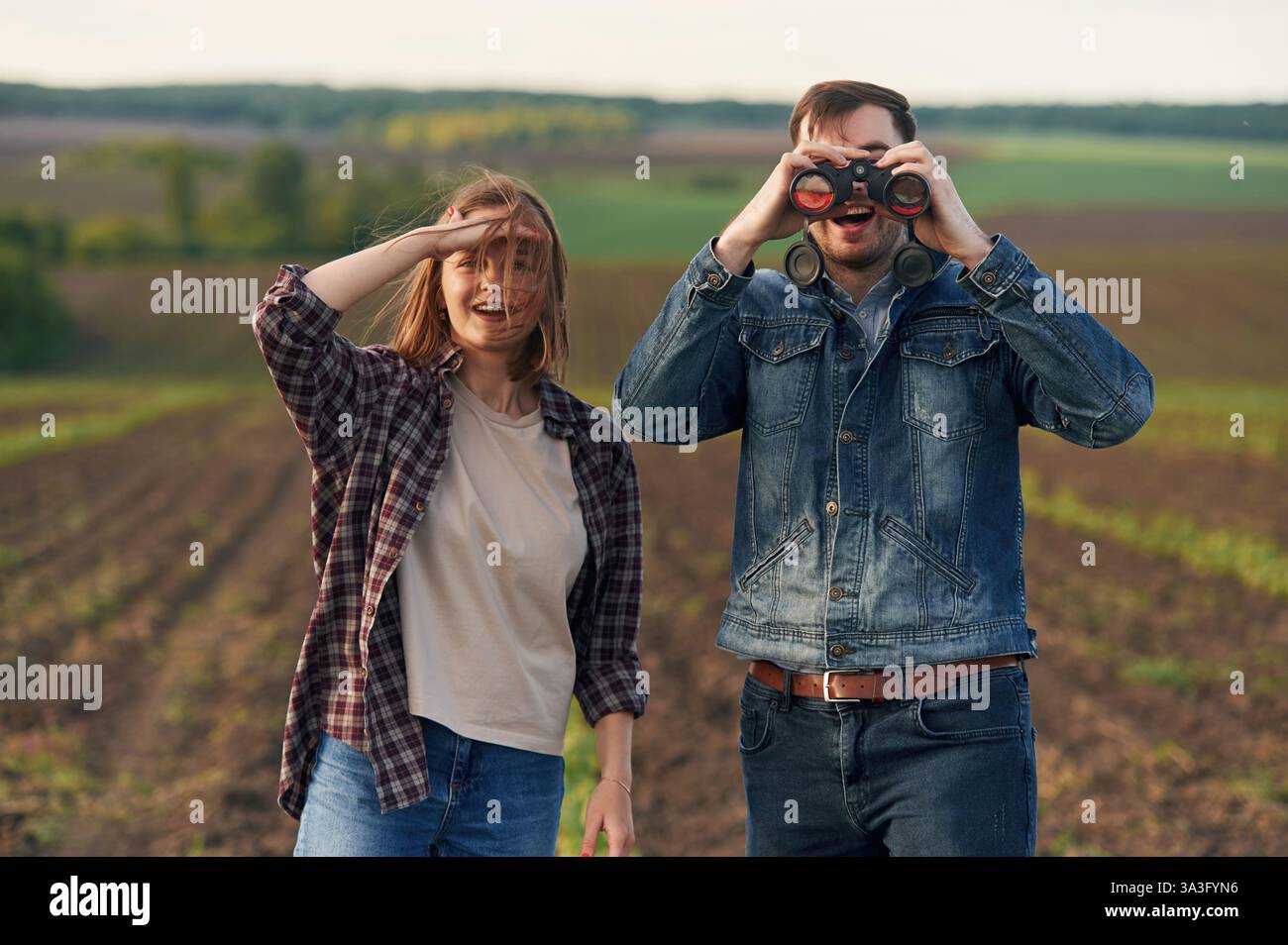 Using binoculars. Lovely beautiful couple are together on the ...