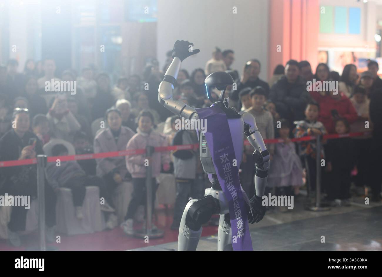 A Unitree G1 humanoid robot performs for the audience at a robot concert held at Intime City in ...