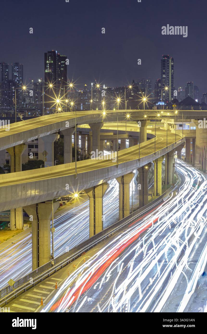 Bangkok, Thailand - Jan 10, 2025 - A nightscape view with bright glowing light trails effect of ...
