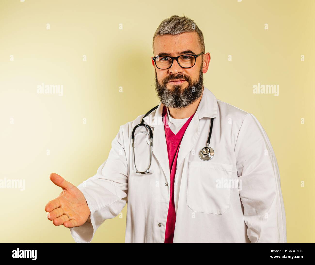 A young, enthusiastic male doctor wearing scrubs and a stethoscope ...