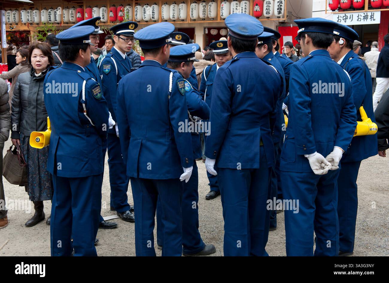 Group of Japanese law enforcement policemen in uniform having a meeting ...