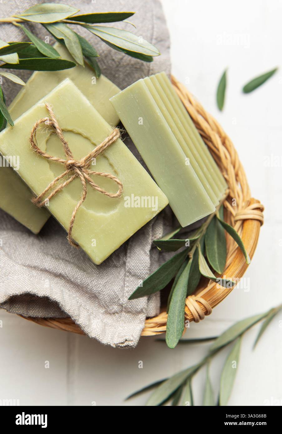 Homemade olive soap bars with olive tree branch in wicker basket on ...
