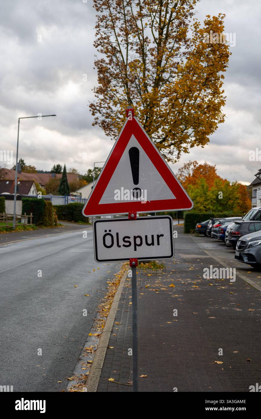 Danger from oil slick: warning sign on the side of the road Stock Photo ...