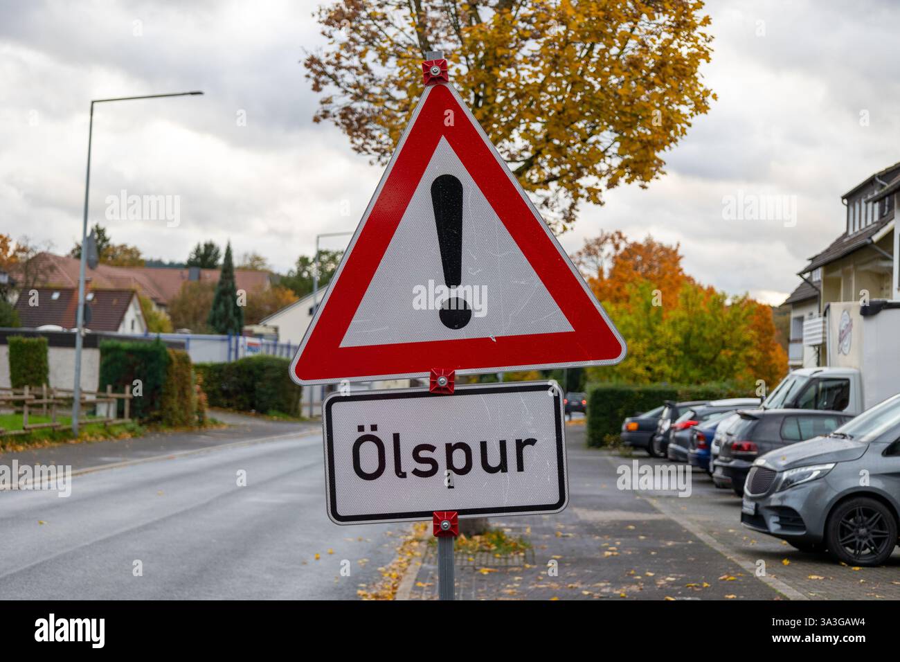 Danger from oil slick: warning sign on the side of the road Stock Photo ...