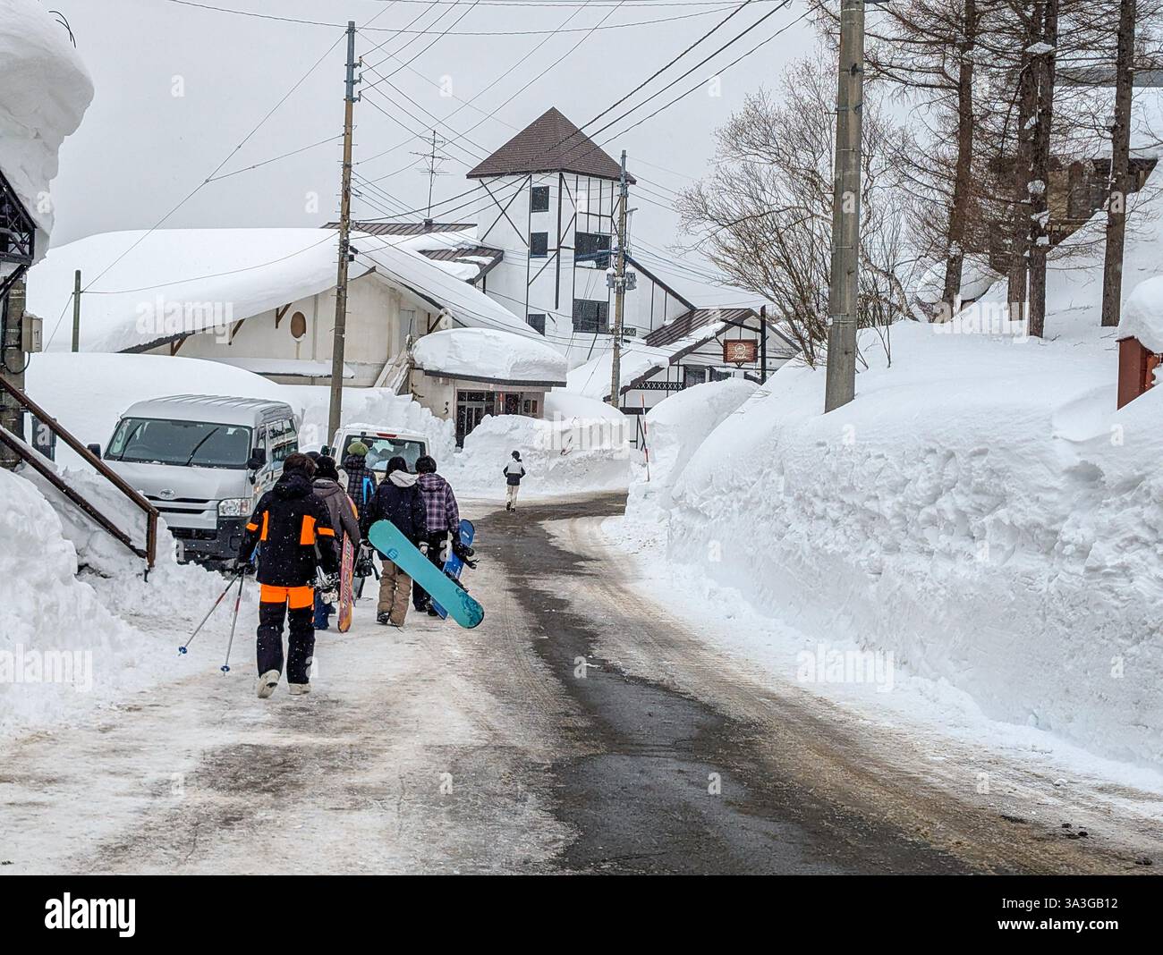 MADARAO,JAPAN - 02 14 2025: Skiers walking through deep snow in Madarao ...