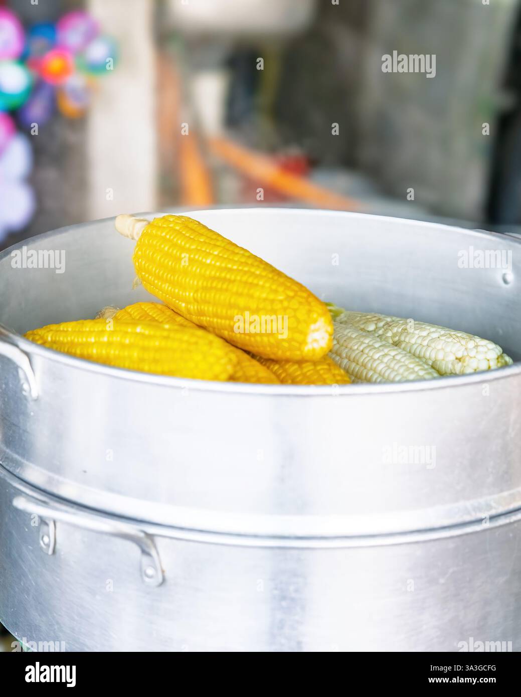 Yellow corns being steamed in the pot Stock Photo - Alamy