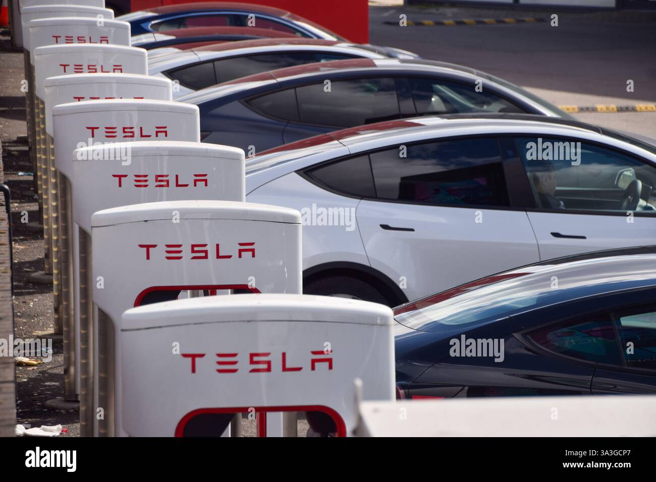 March 15, 2025, London, England, UK: Cars charge at the Tesla Centre in ...