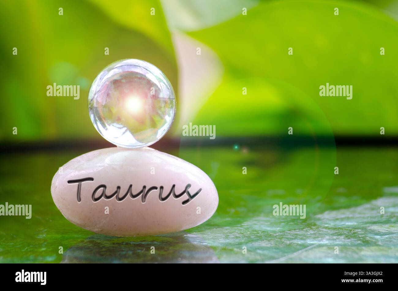 Taurus text engraved on Zen stone with shining glass marble on top ...