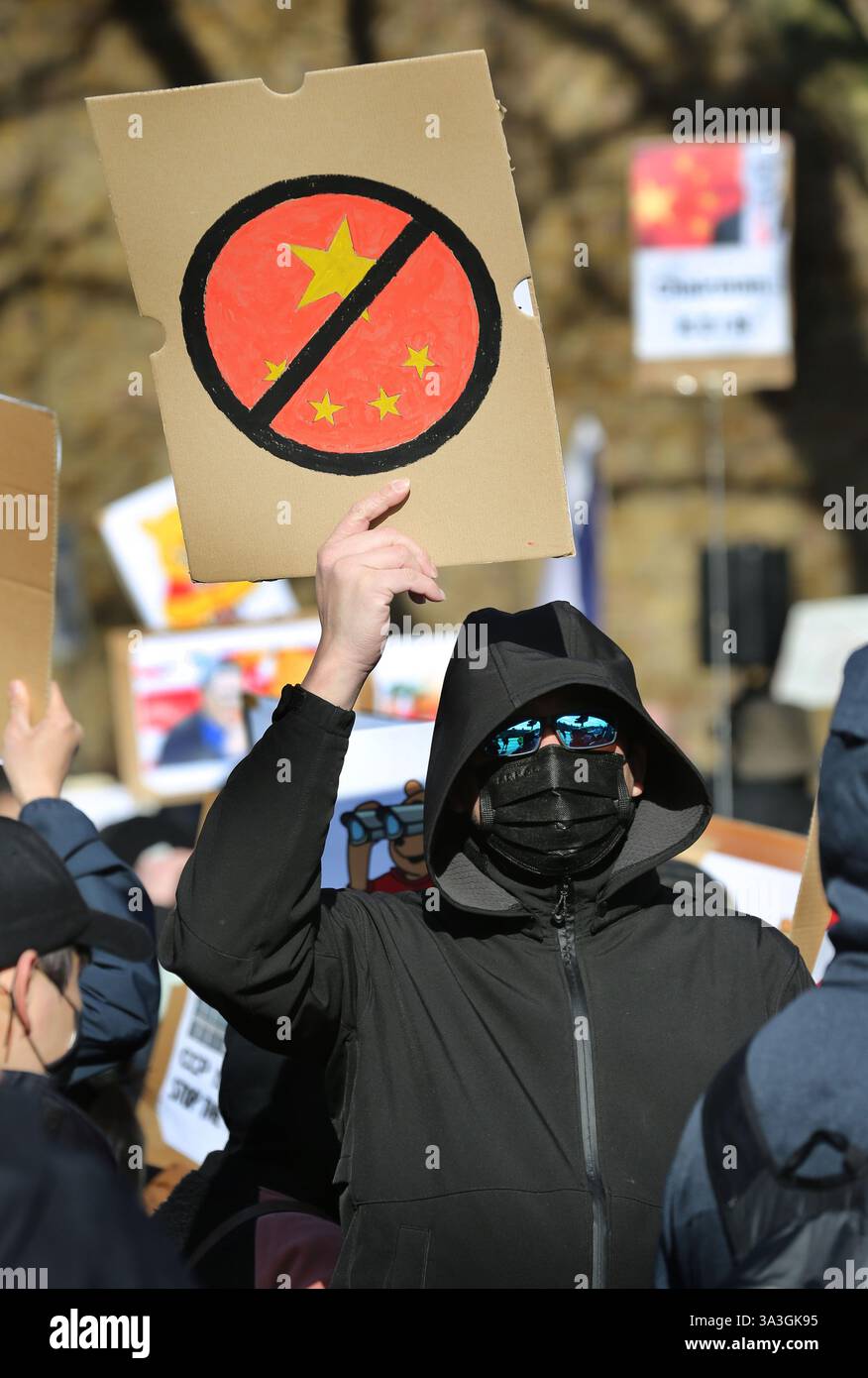 A protester holds a sign saying ‘No To China' during the demonstration ...