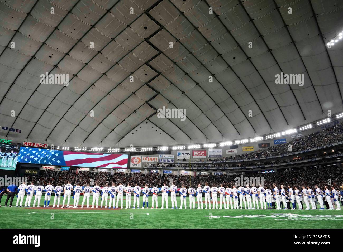 The Chicago Cubs line up on the field at the Tokyo Dome before their ...
