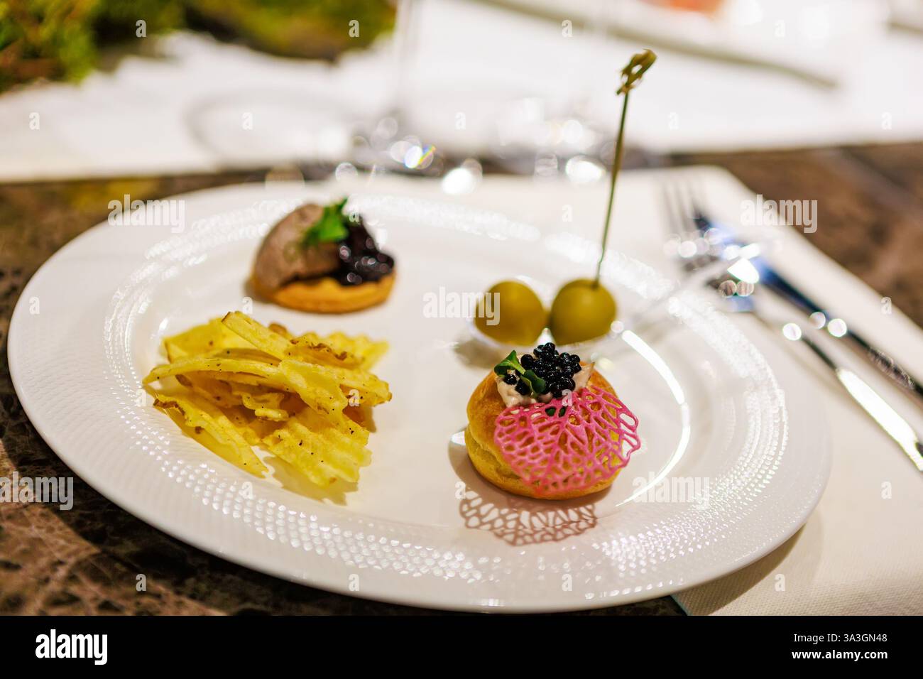 Elegant gourmet appetizers served on white porcelain Stock Photo - Alamy