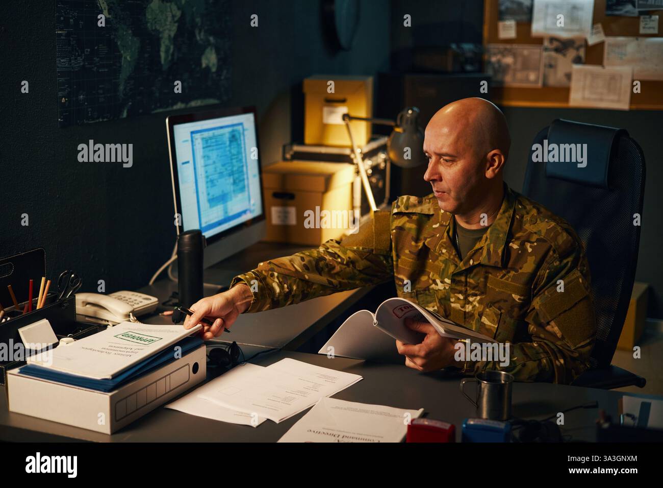Military Officer Reviewing Documents at Desk Stock Photo - Alamy