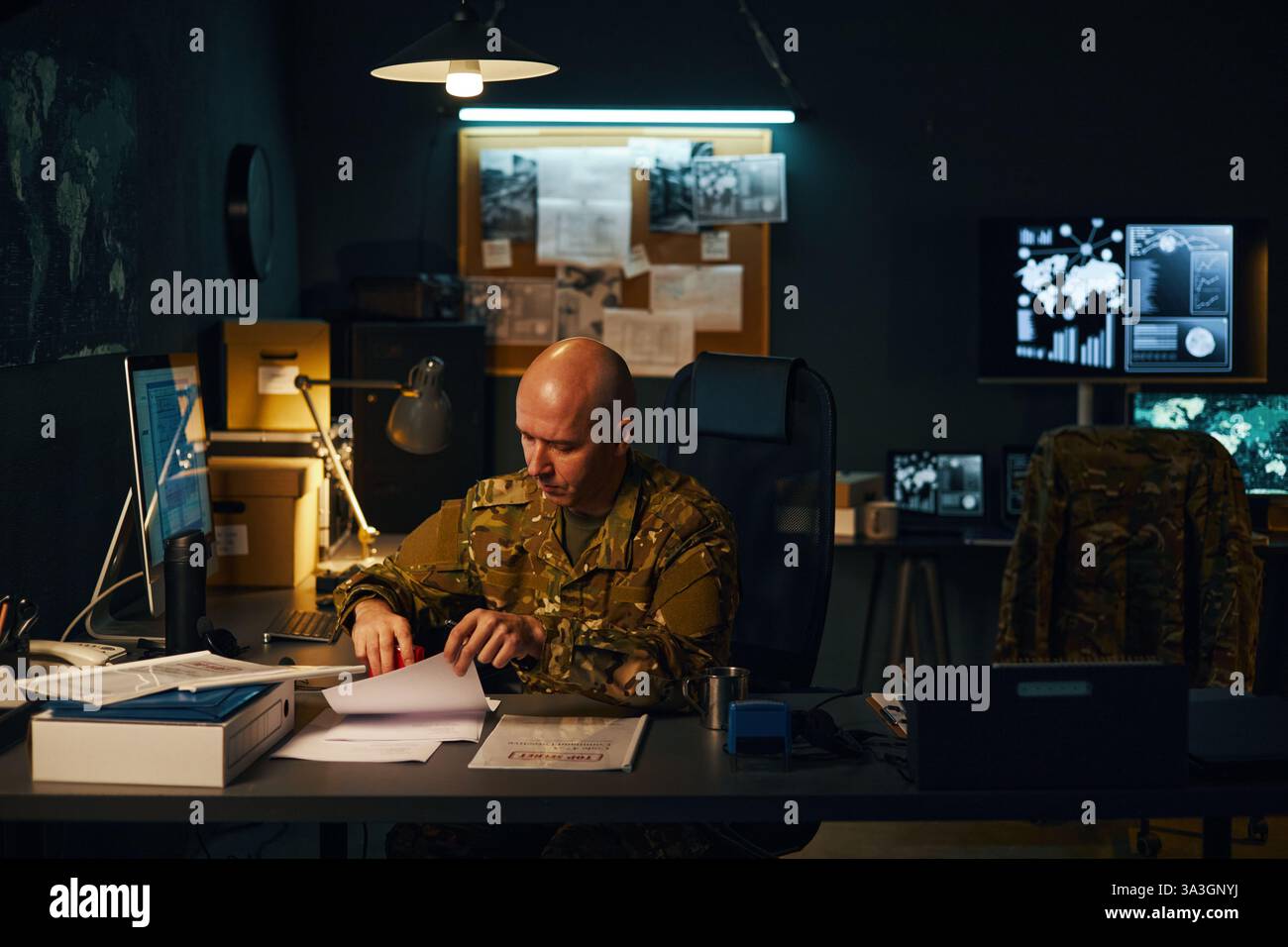 Military Personnel Analyzing Documents in Office Setting Stock Photo - Alamy