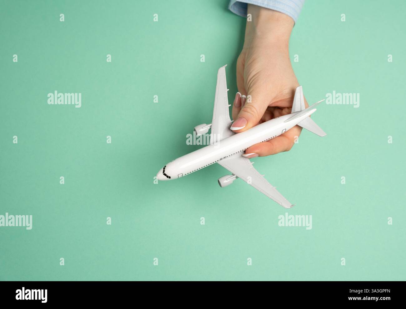 Passenger plane in hand. Air travel. Vacation planning, global mobility ...