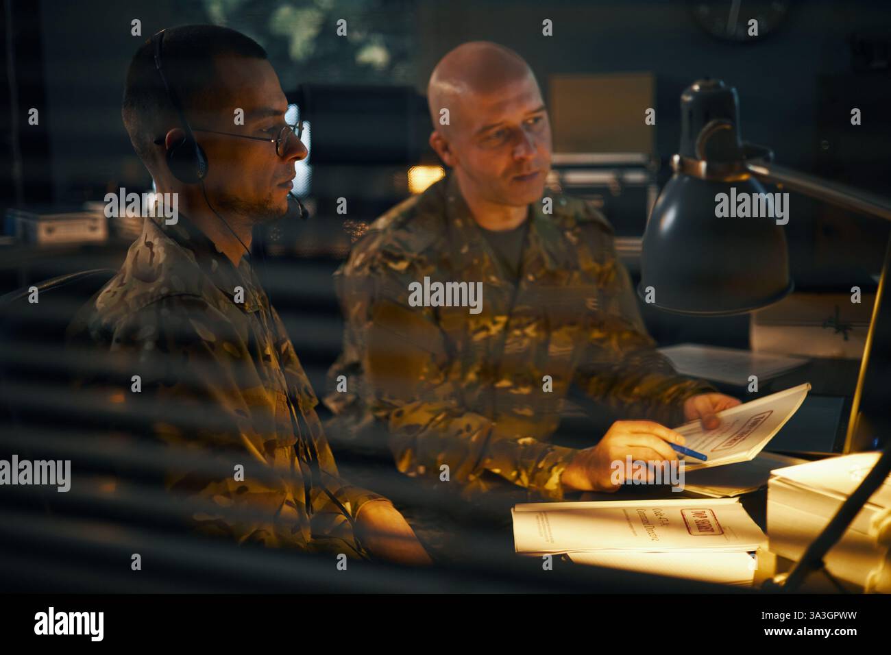 Military Officers Collaborating During Night Operations Stock Photo - Alamy