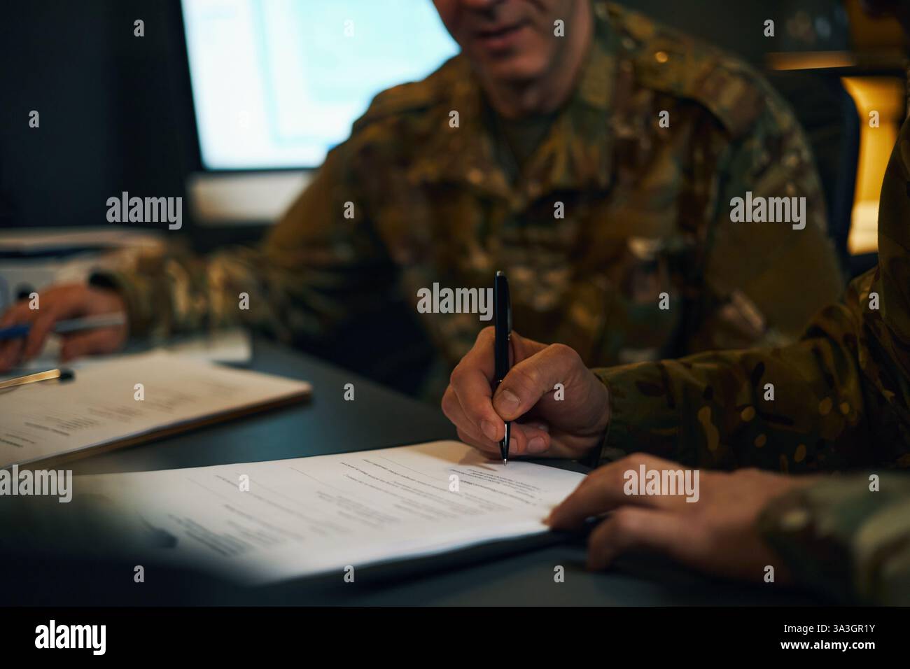 Signing Military Documents in a Dimly Lit Office Stock Photo - Alamy