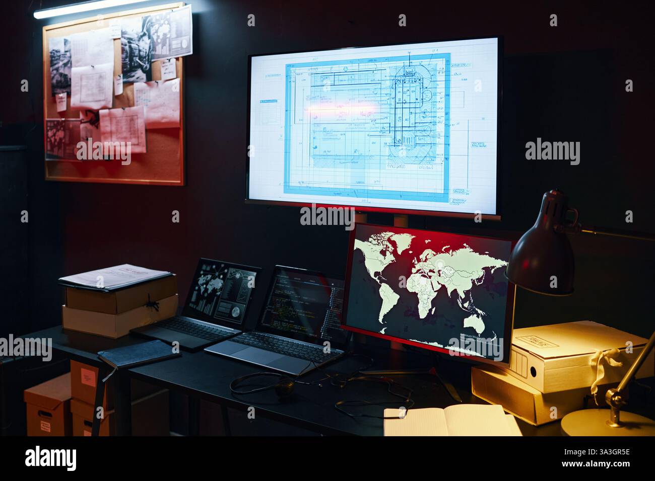 Examining Blueprints and World Map on Monitors Stock Photo - Alamy
