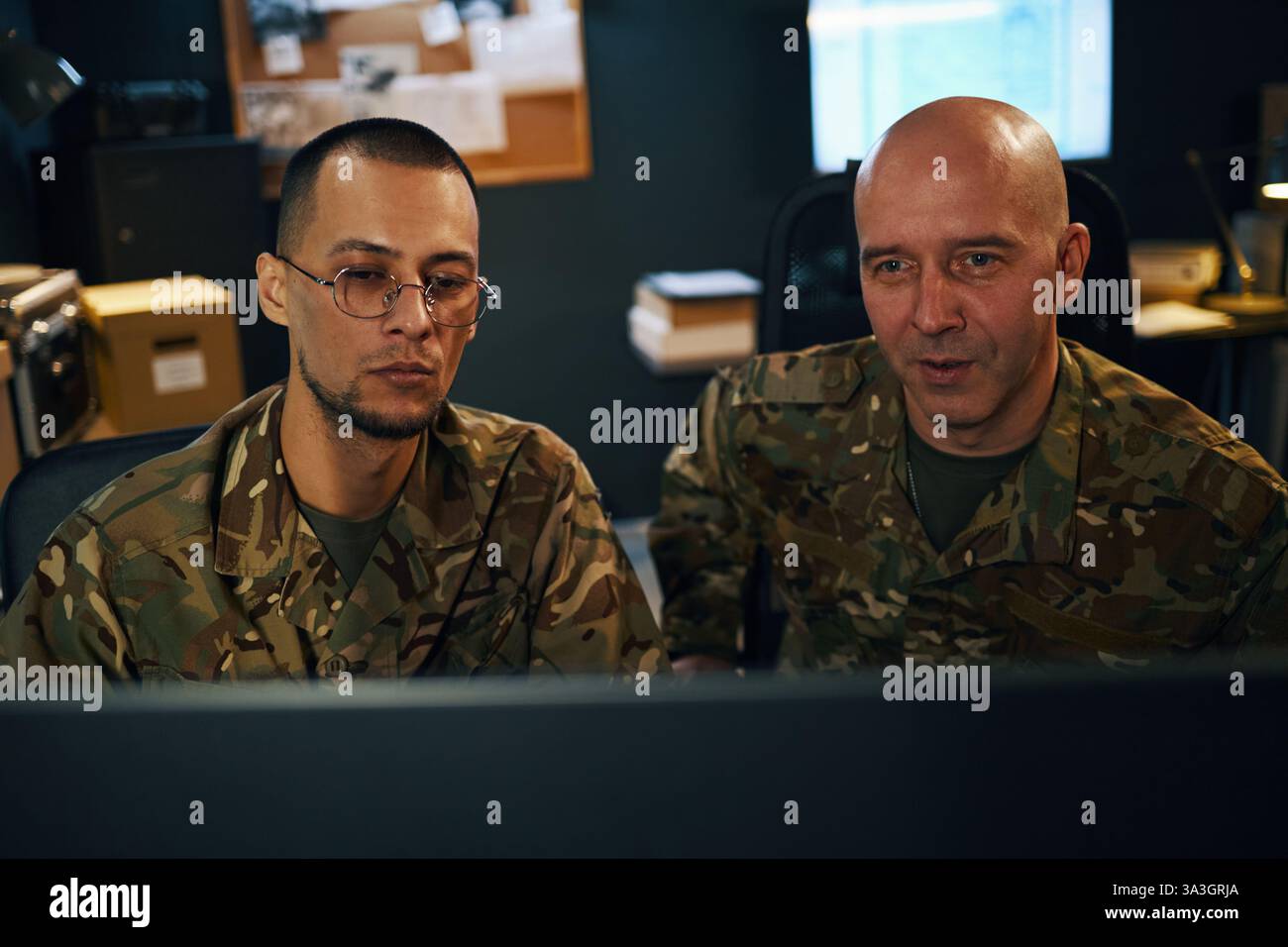 Analyzing Data in Military Office Setting Stock Photo - Alamy