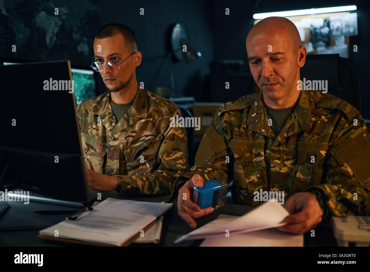Analyzing Military Documents in Command Center Stock Photo - Alamy