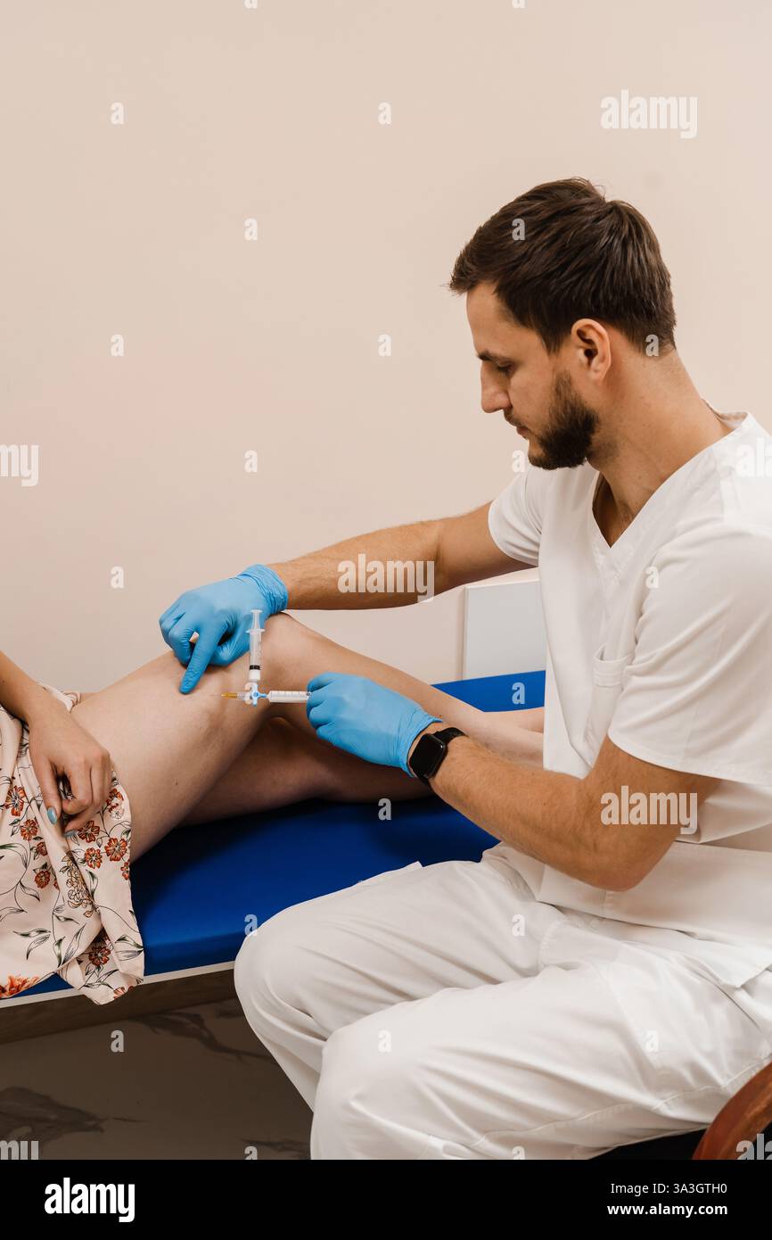 Vascular surgeon injects chemical solution into woman leg for ...
