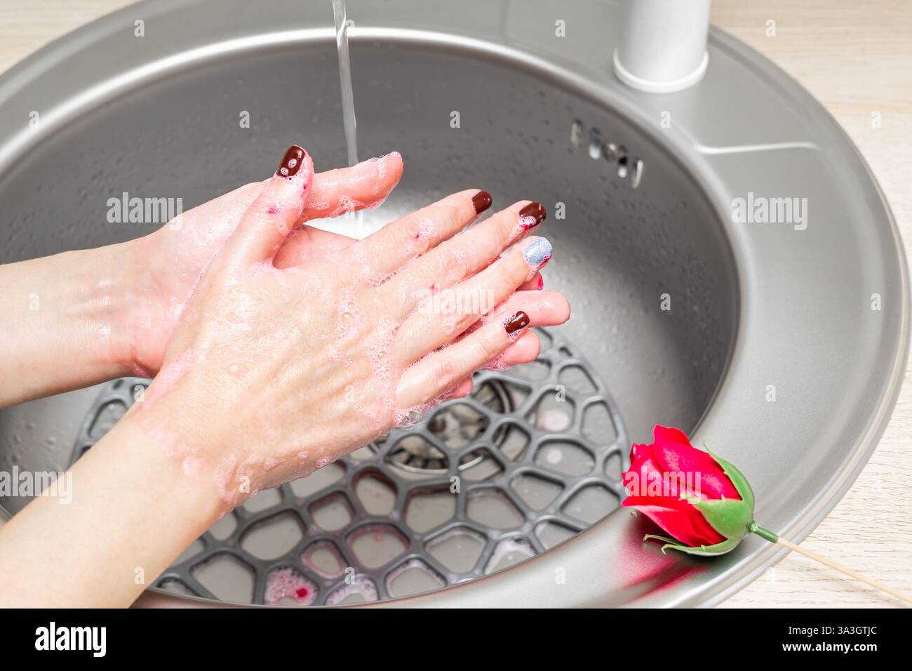 Woman washes hands red hi-res stock photography and images - Alamy