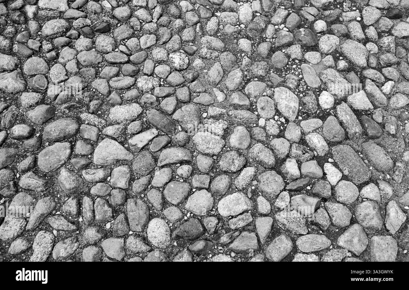 Vintage road pavement with gray round granite stones in ground, top ...