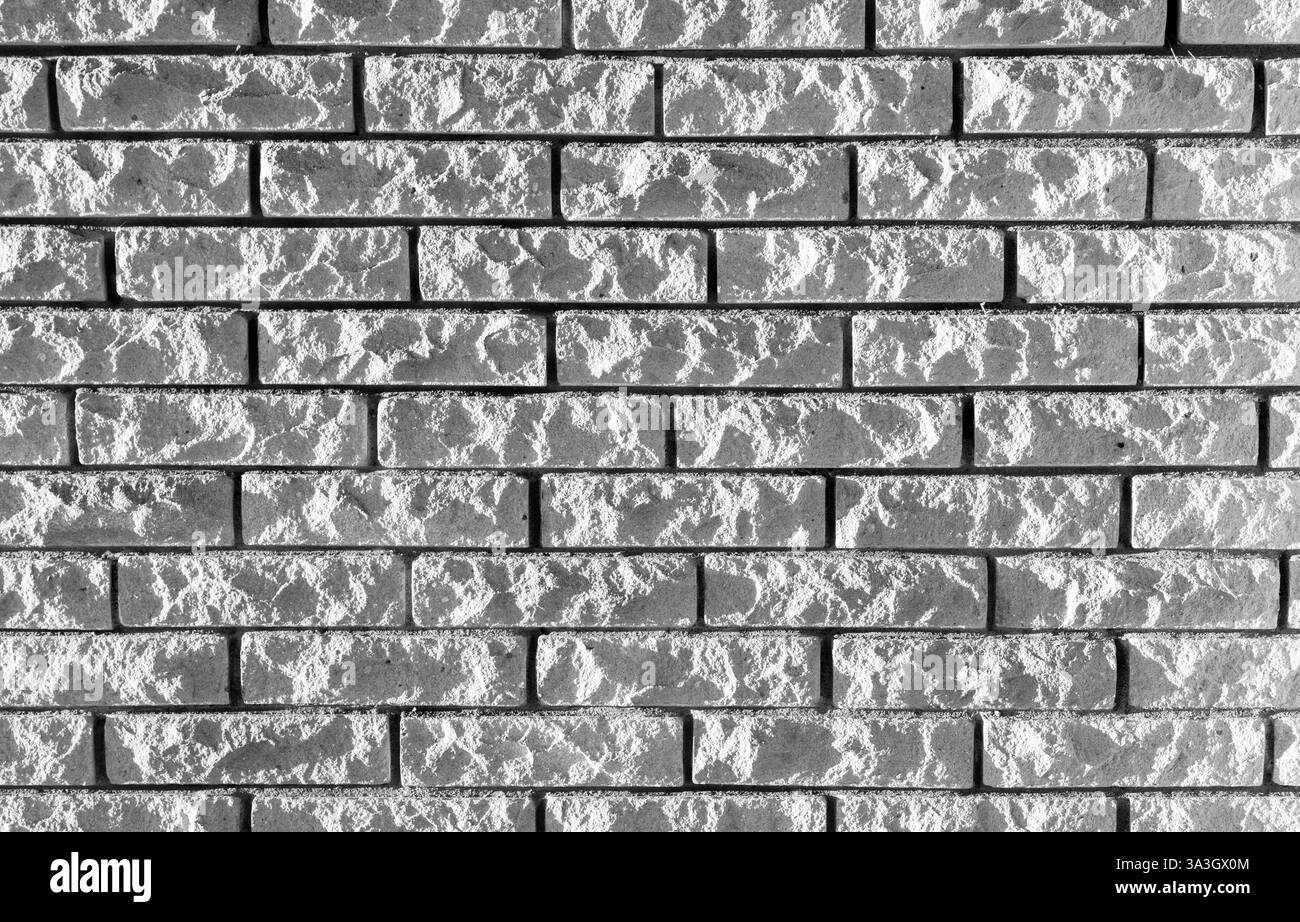 Background texture of gray rough brick wall, front view. Black and ...