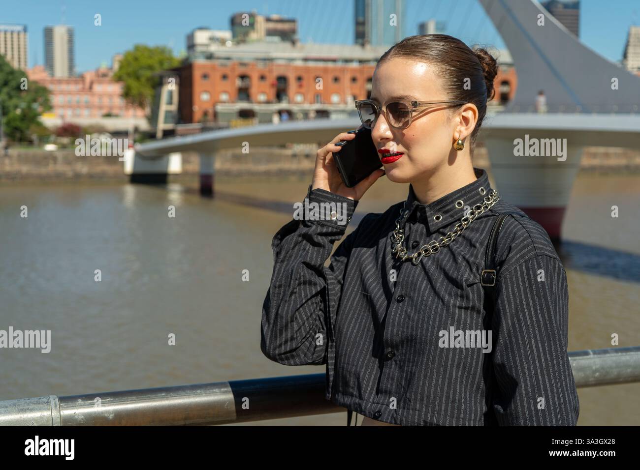 Businesswoman having a phone call in puerto madero, the modern ...